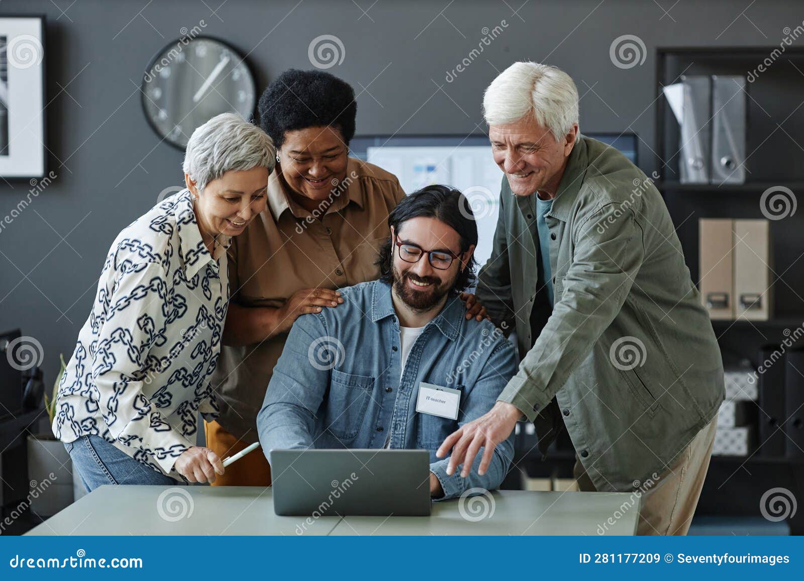 Diverse Group of Smiling Senior People Using Laptop with Man in ...