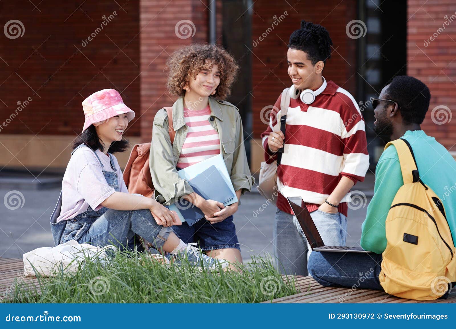 Diverse Group of Students Chatting Outdoors on Campus and Smiling Stock ...
