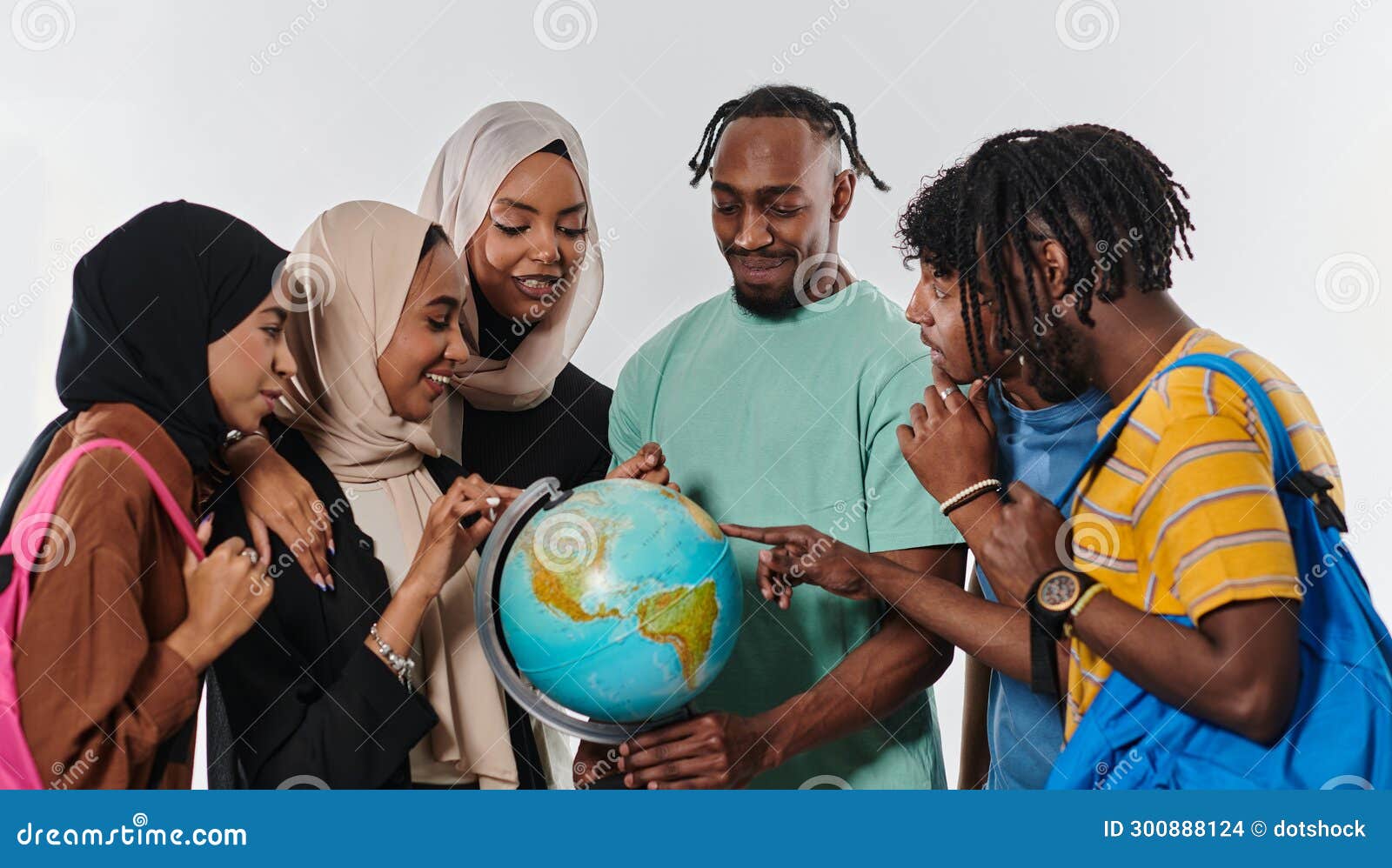 A Diverse Group of Students is Gathered Around a Globe, Engrossed in ...