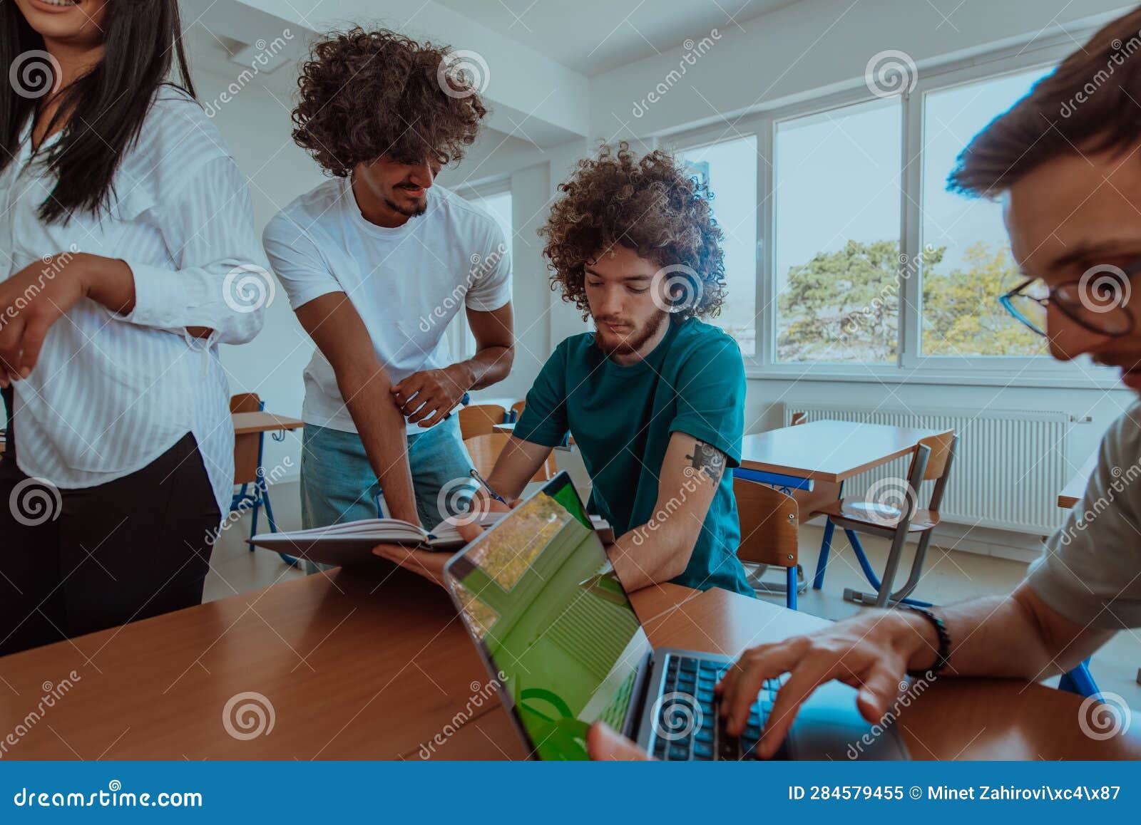 A Diverse Group of Students Gathers in a Modern School Classroom ...