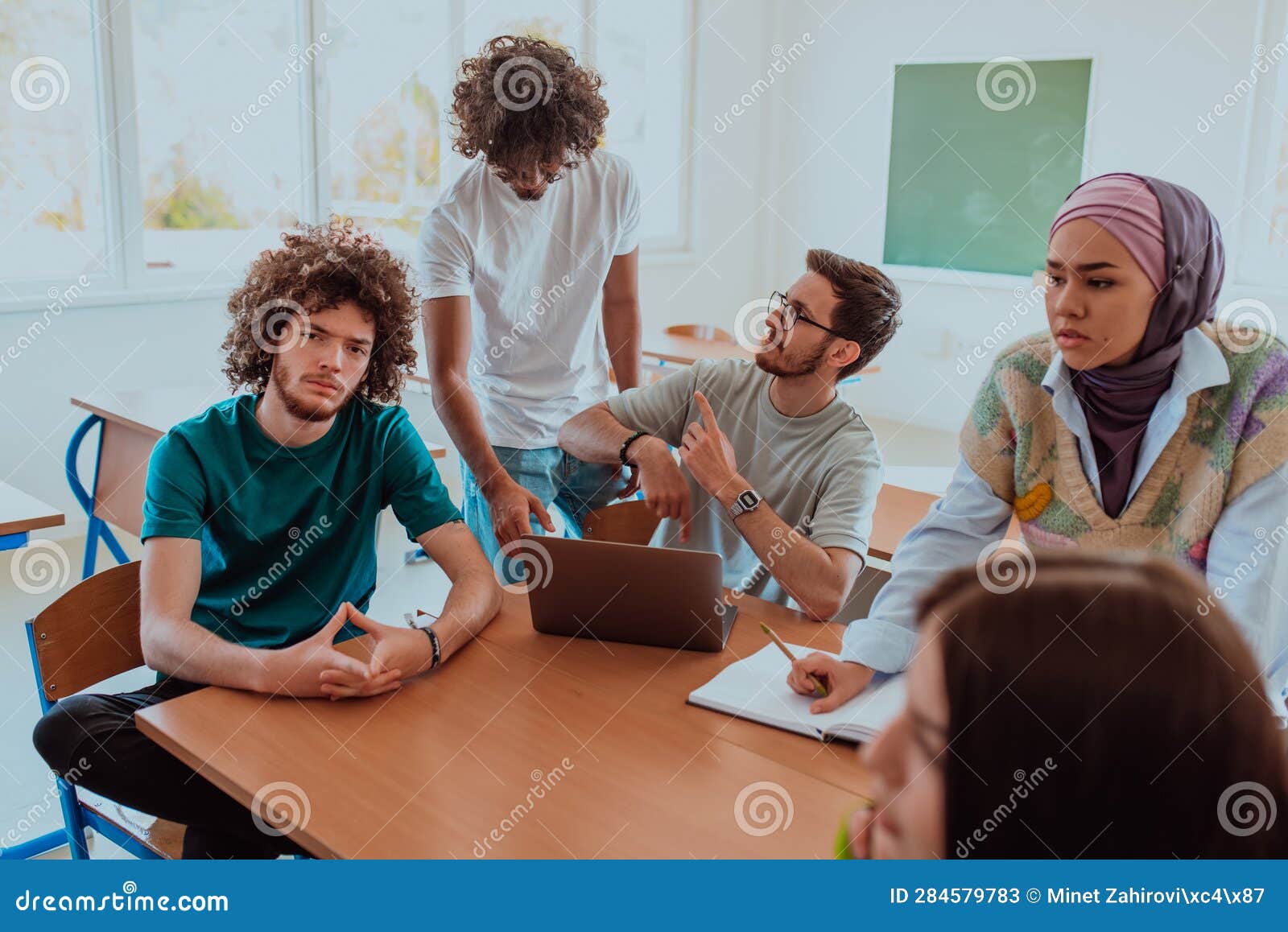 A Diverse Group of Students Gathers in a Modern School Classroom ...