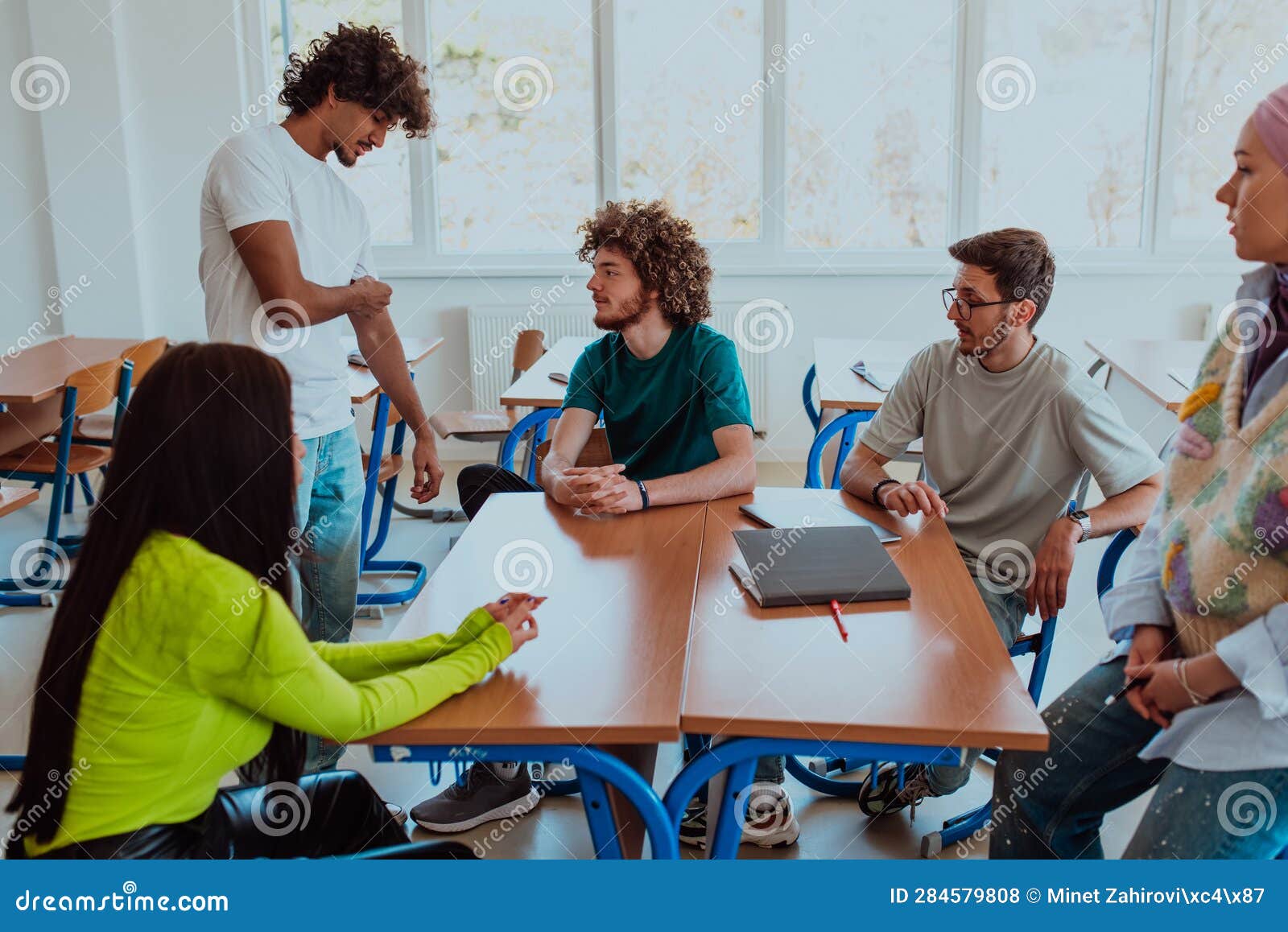 A Diverse Group of Students Gathers in a Modern School Classroom ...