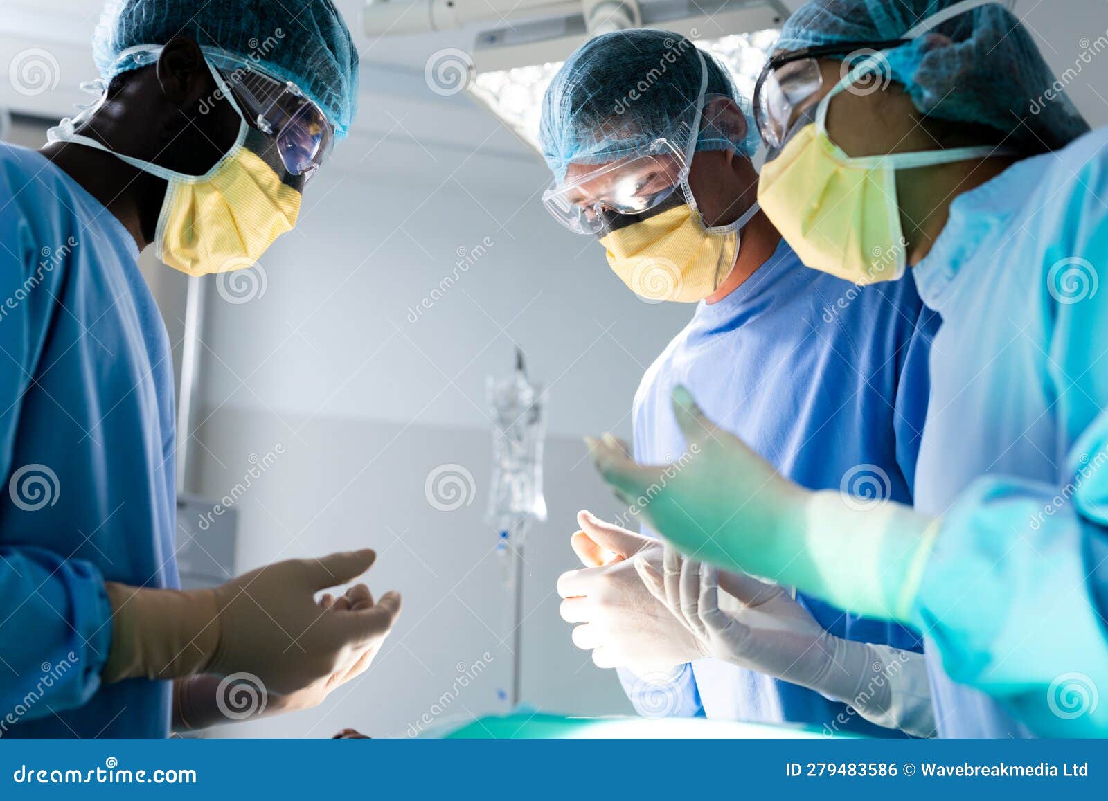 Diverse Group of Surgeons Talking during Surgery in Operating Theatre ...