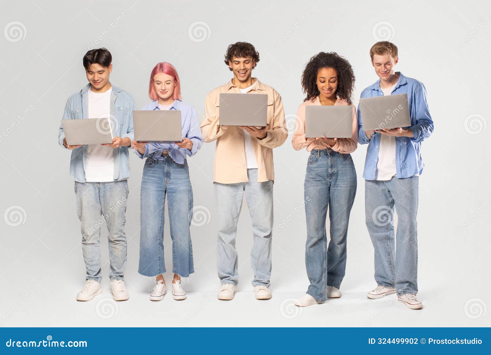 Diverse Group of Young Adults Using Laptops in Studio Setting Stock ...