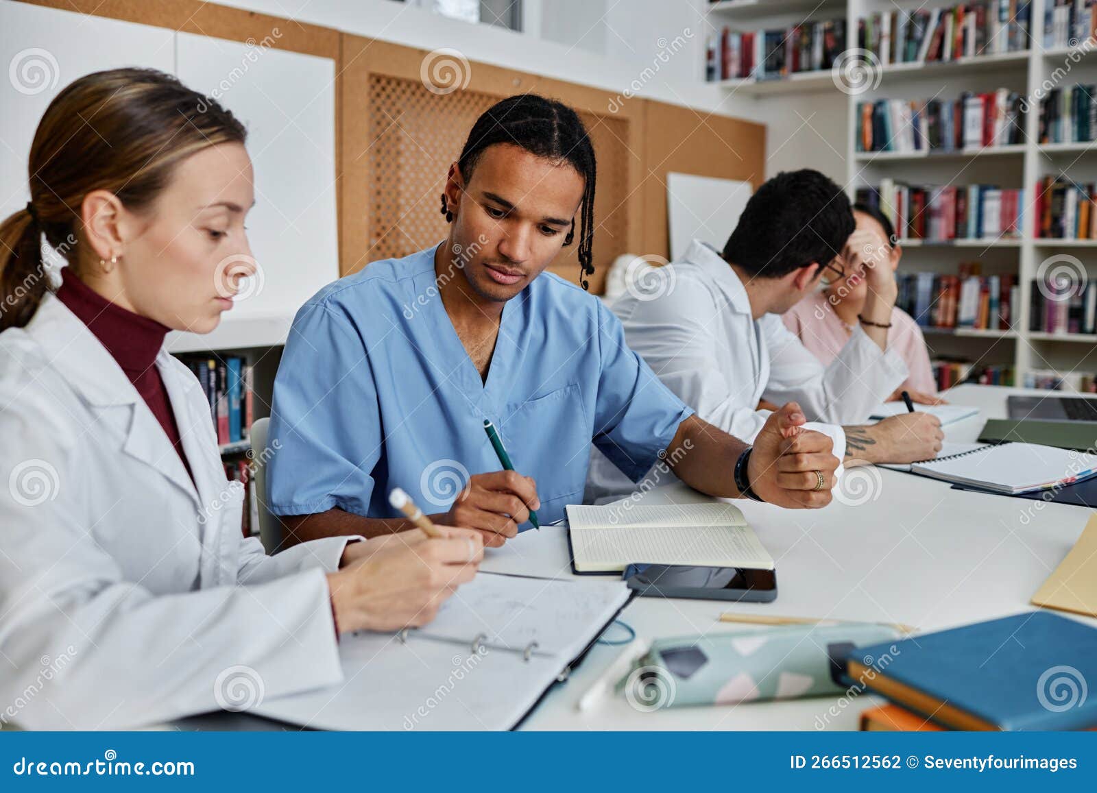 Diverse Group of Young Medics and Nurses Working during Meeting or ...