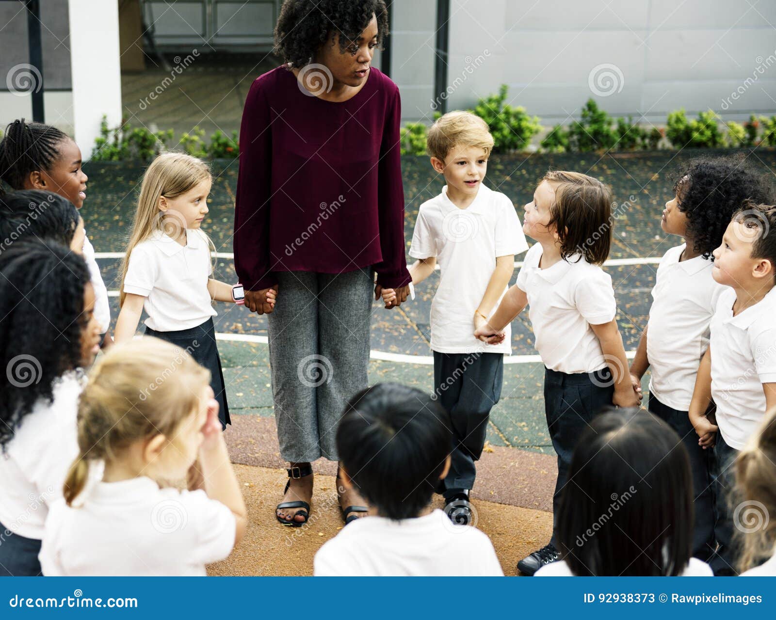 Diverse Kindergarten Students Standing Holding Hands Together Stock ...