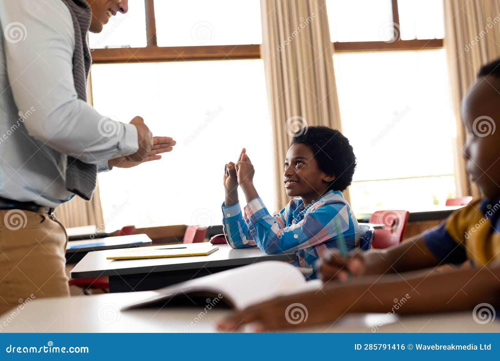 Diverse Male Teacher Teaching School Boy Using Sign Language in Class ...