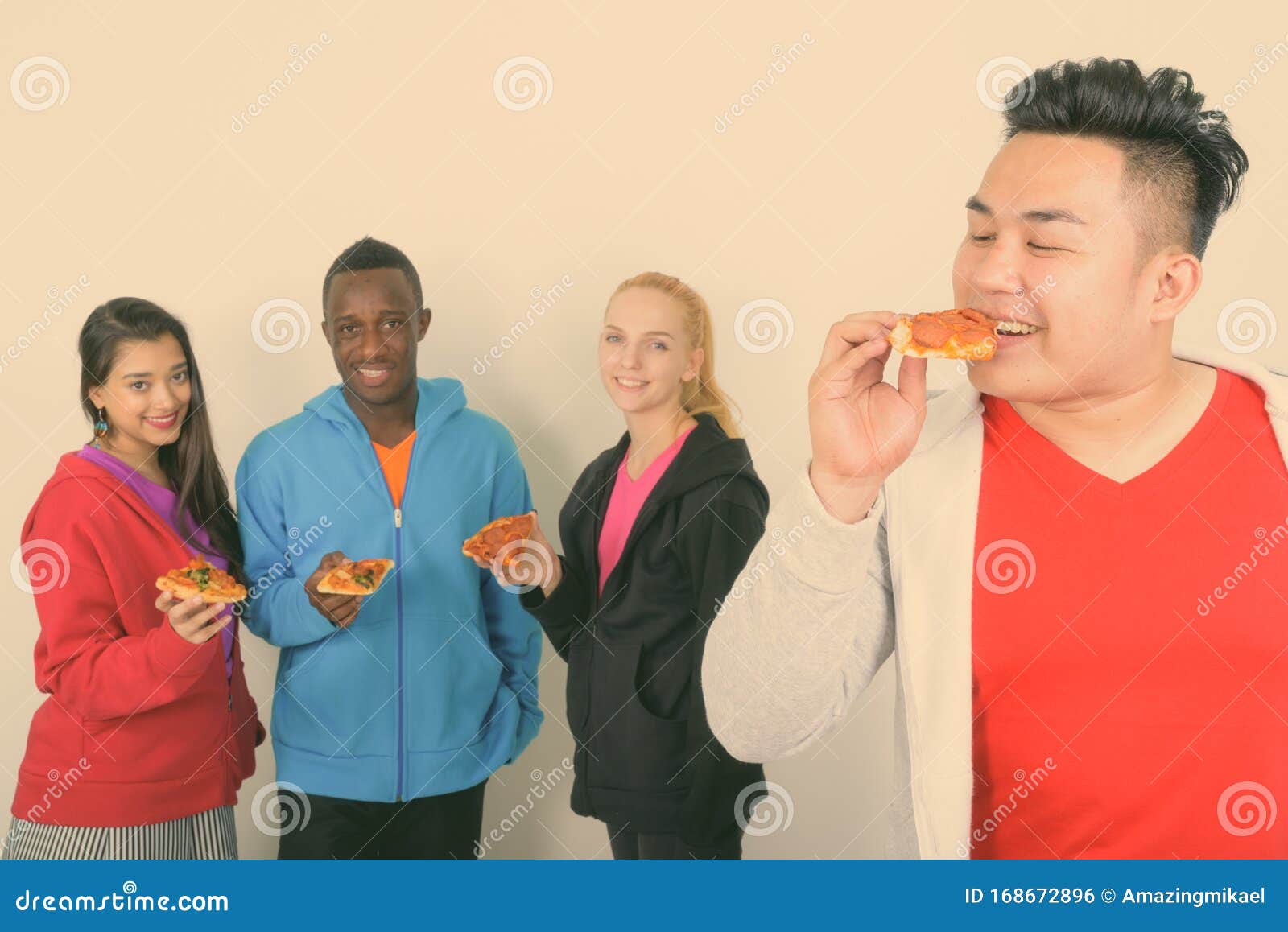 Diverse Multi Ethnic Group Of Happy Friends Eating Pizza Together Stock