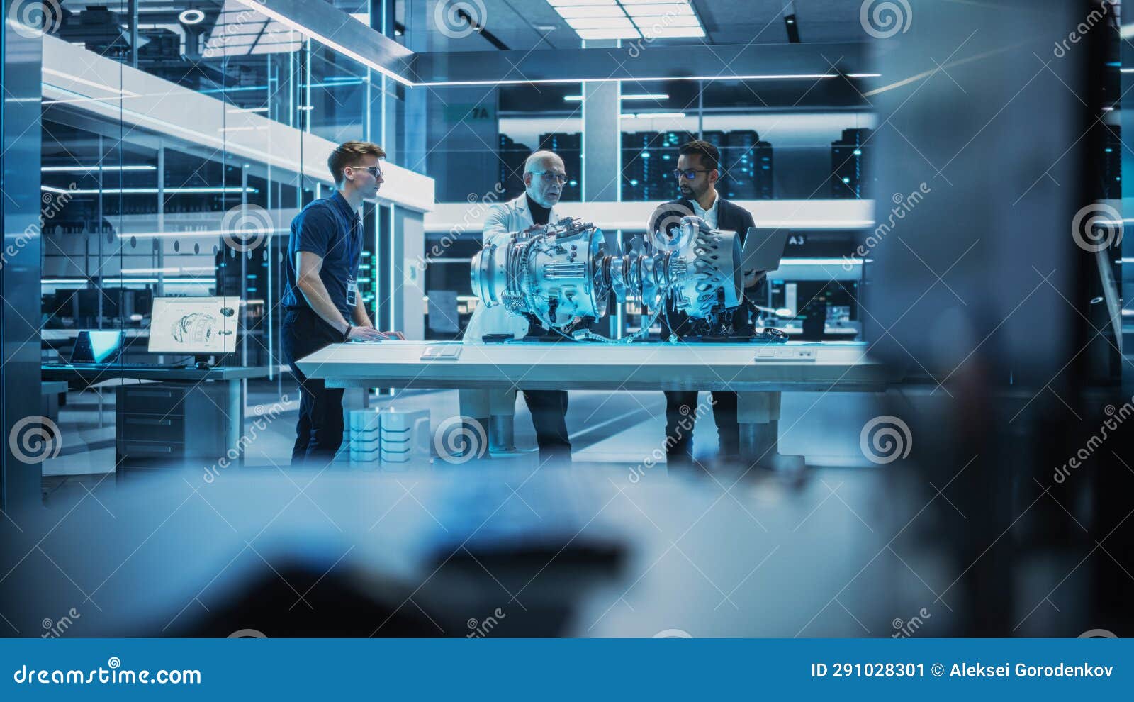 Diverse Multiethnic Team of Industrial Engineers Gathered Around a ...