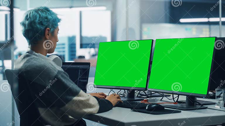 In Diverse Office: Female Programmer is Working on Green Screen Computer, Chroma Key and Coding ...