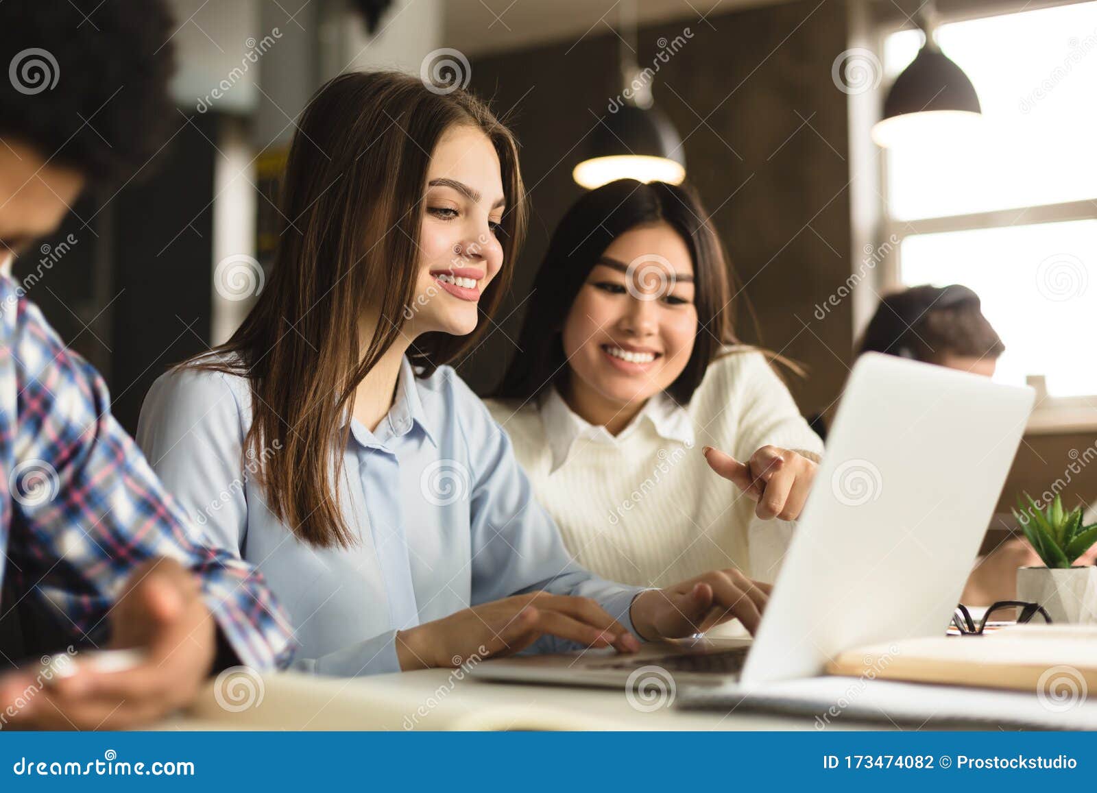 Diverse Student Girls Networking on Laptop in Library Stock Photo ...