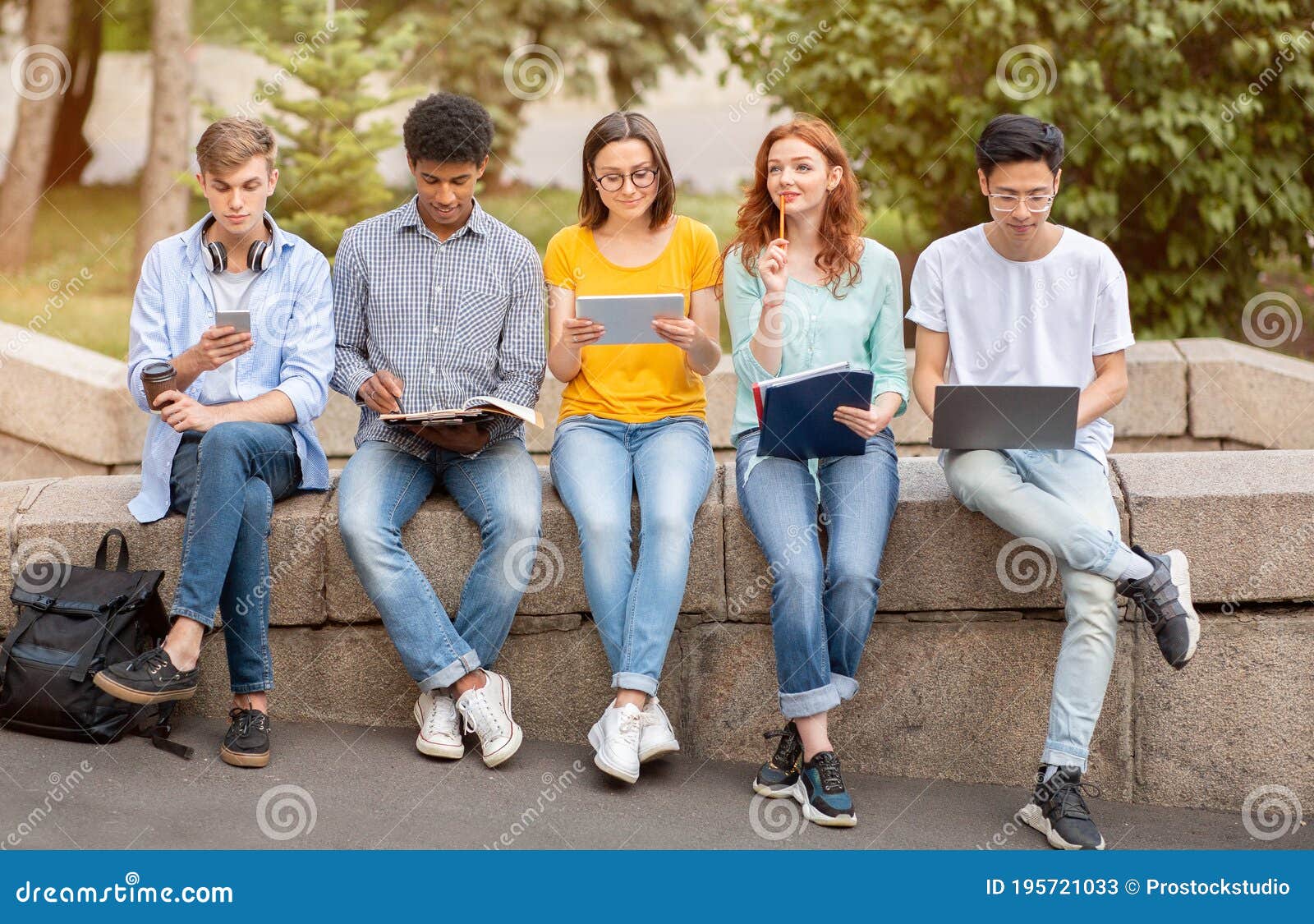 Diverse Students Learning Using Laptop and Tablet Computers Sitting ...