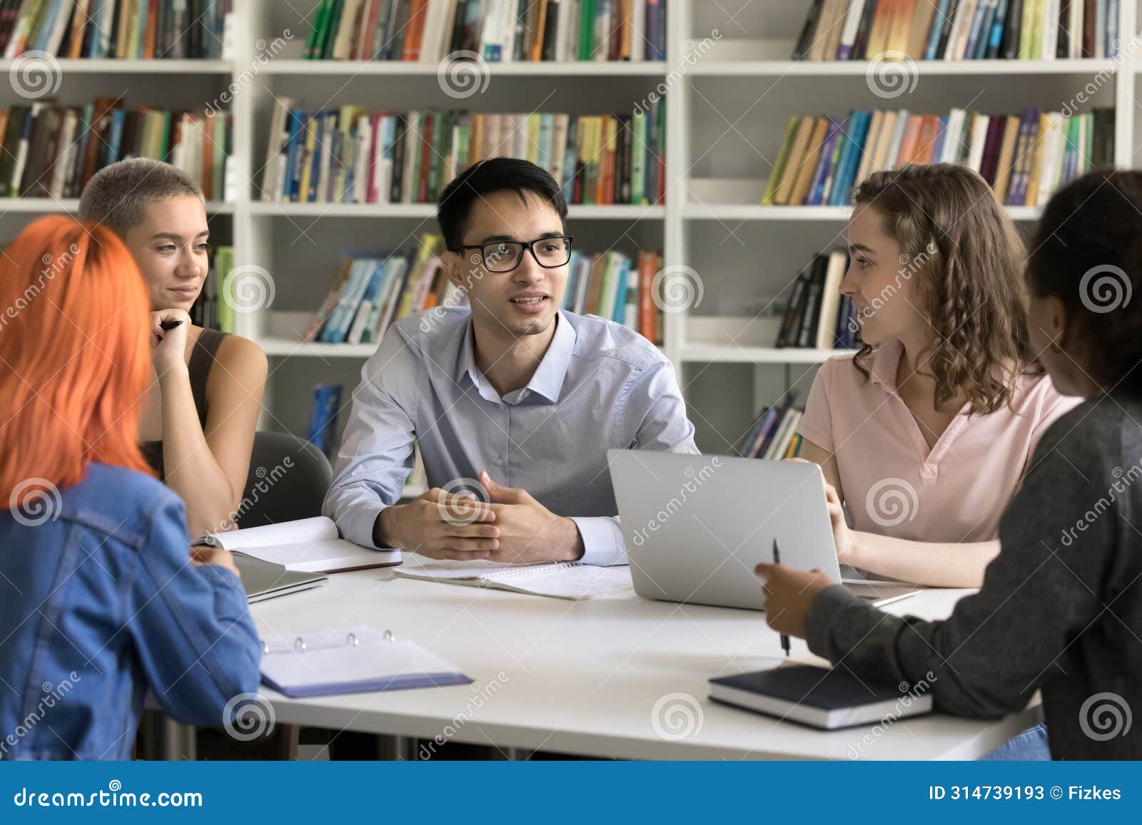 Diverse Students Share Ideas Engaged in Teamwork in College Library ...