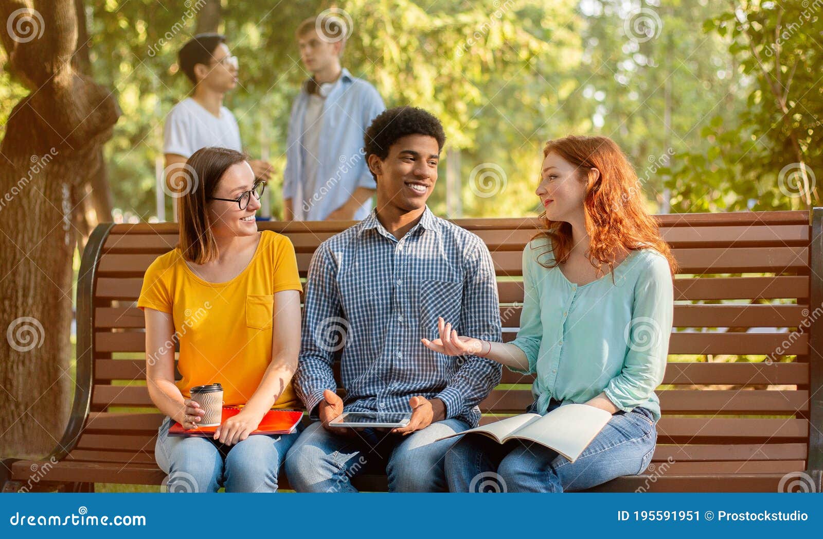 Diverse Students Talking Sitting on Bench Outdoors after Classes Stock ...
