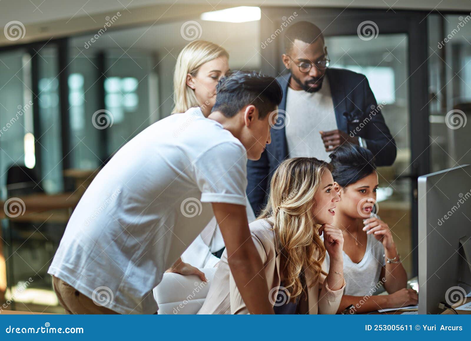 Diverse Team of Business People Looking at a Computer Screen Together ...