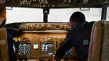 Diverse Team of Captain and Copilot in Cockpit Flying Airplane Stock ...