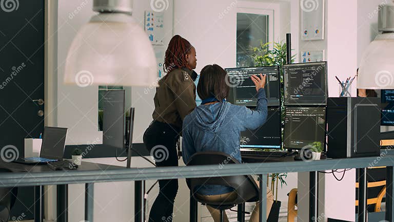 Diverse Team Of Database Admins Analyzing Source Code And Comparing Data Script Stock Image 