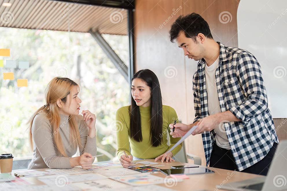 Diverse Team Deep in Discussion while Analyzing Design Materials in an ...