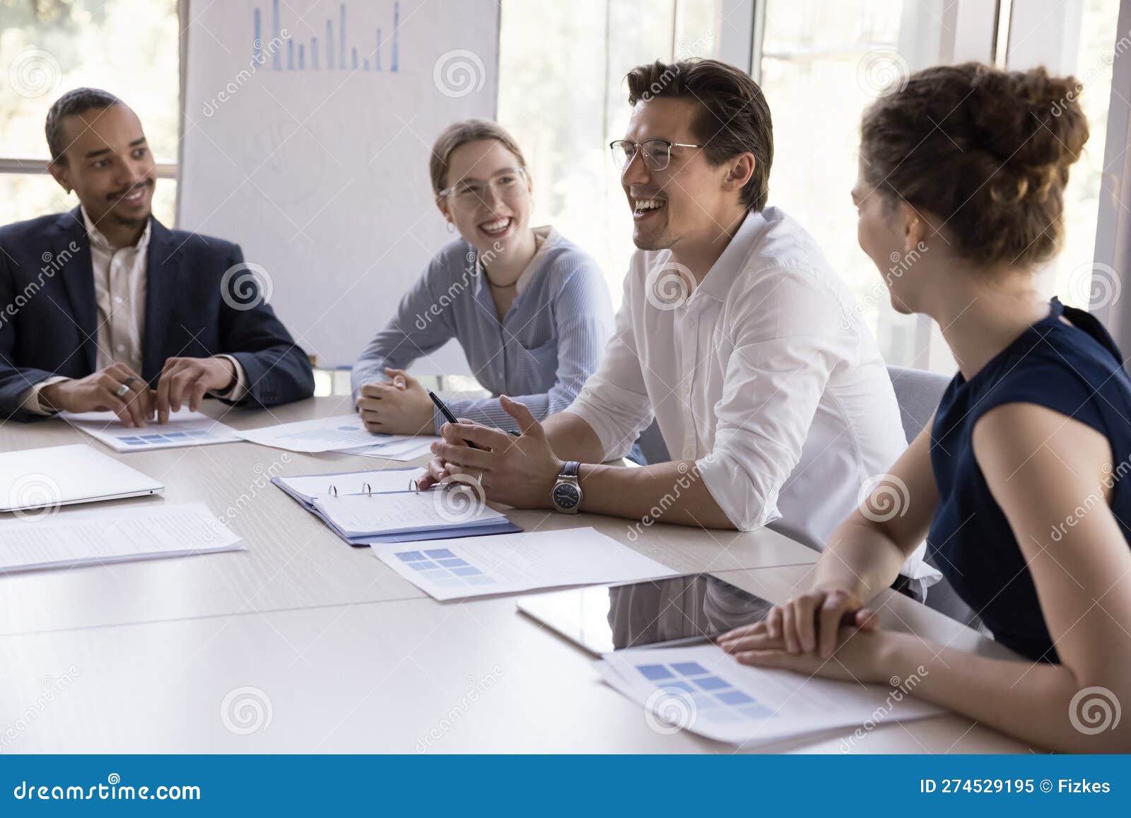 Diverse Team of Happy Young Employees Laughing at Meeting Table Stock ... Diverse Team of Happy Young Employees Laughing at Meeting Table Stock ...