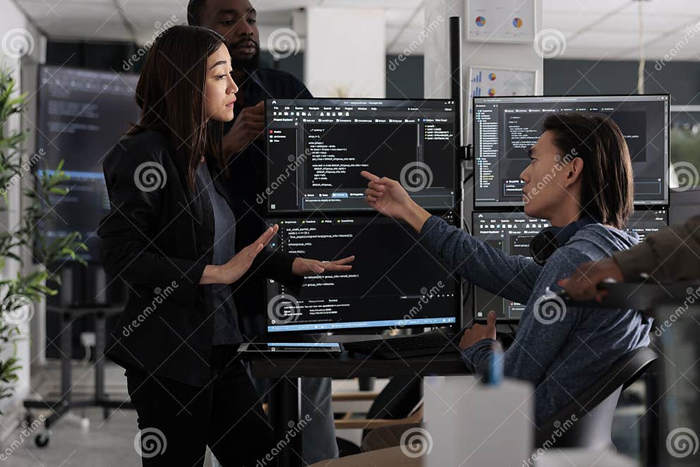 Diverse Team of Programmers Coding Html Script Information on Computer at Desk Table Stock Image ...