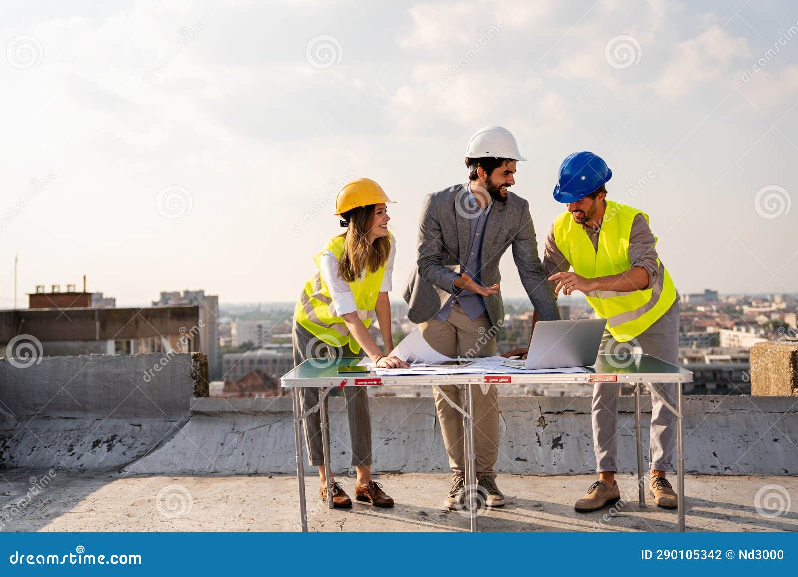 Diverse Team of Specialists with Computer on Construction Site ...