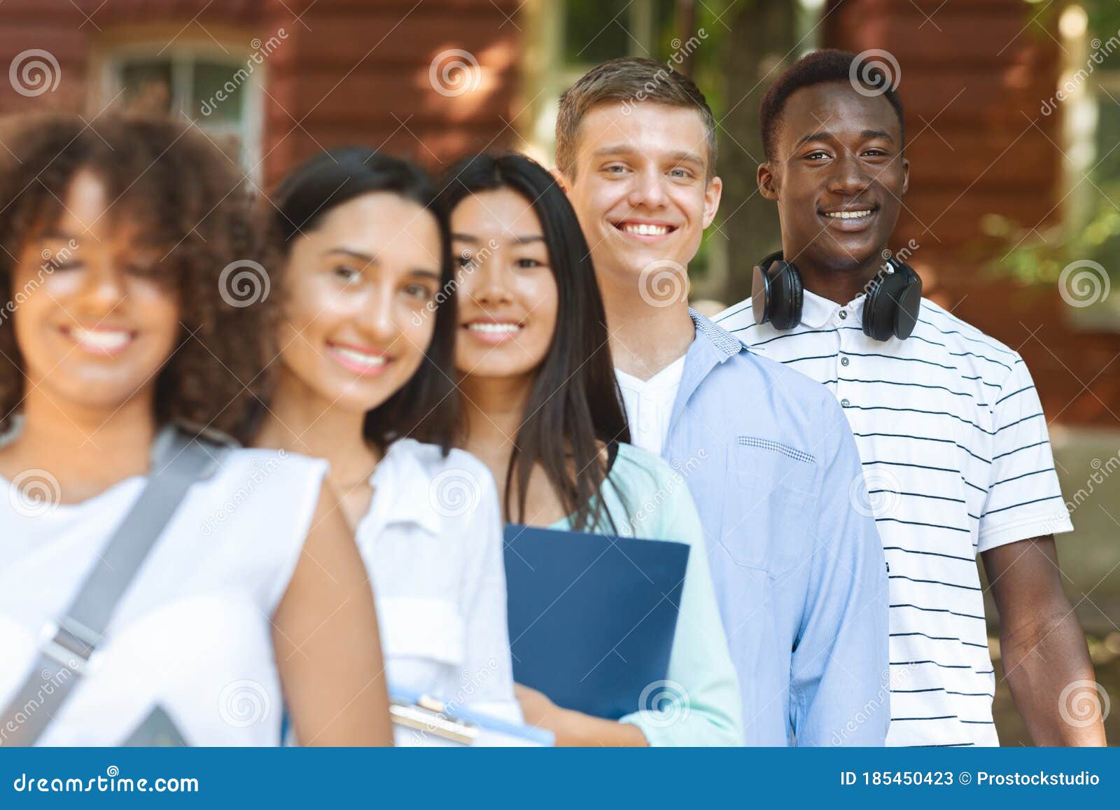 Diverse University Students Standing Outdoors on Campus, Smiling at ...