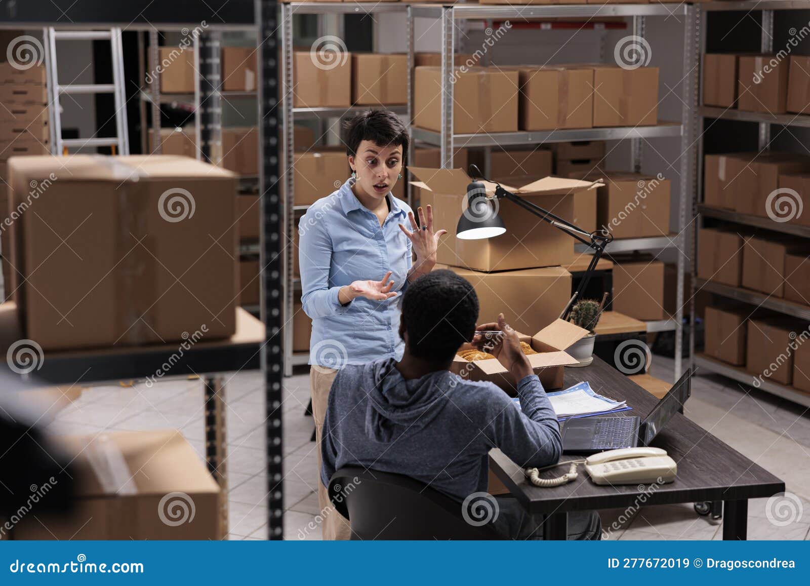 Diverse Warehouse Workers Discussing Distribution Logistics Problem ...