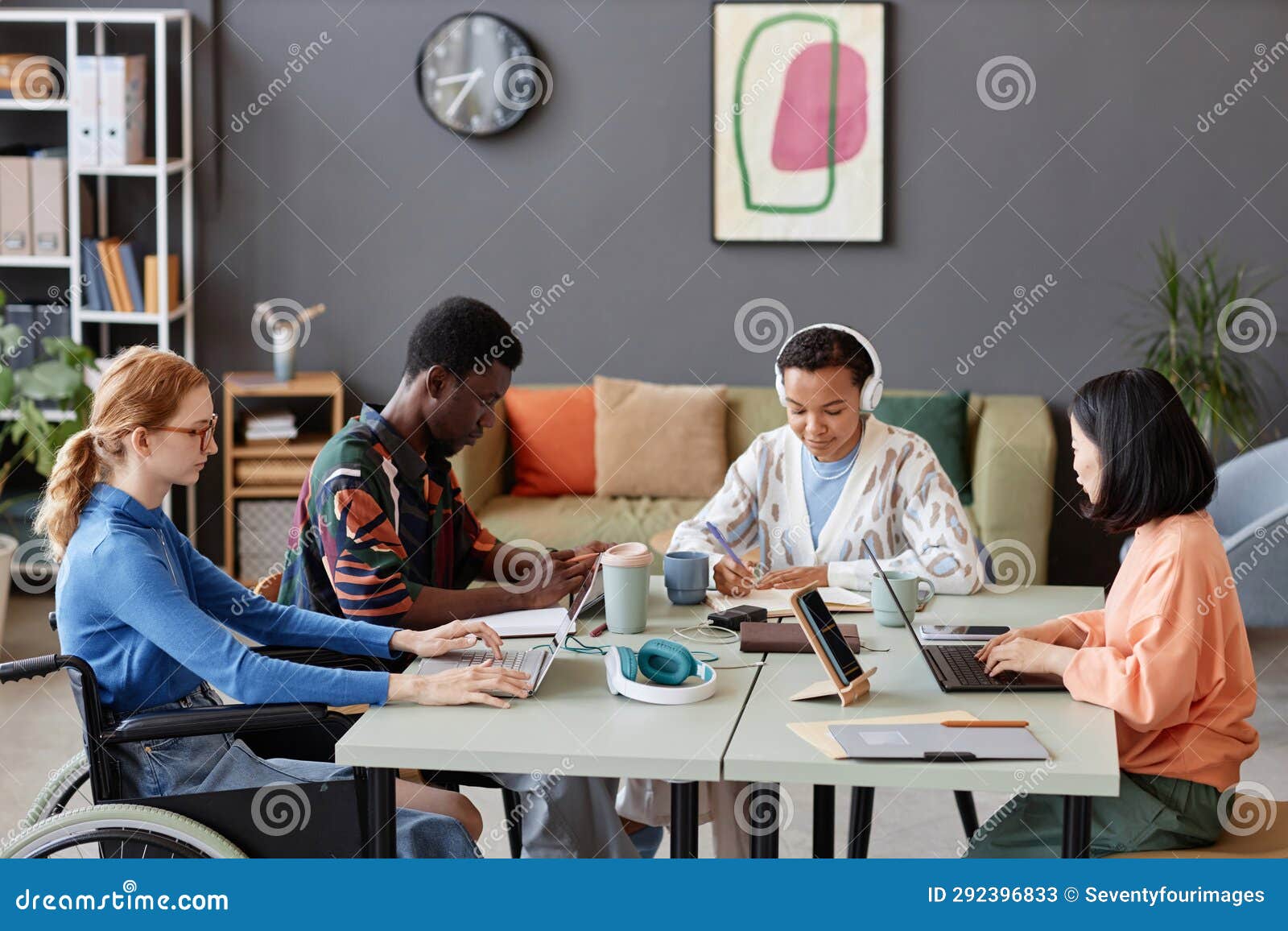 Diverse Young Team Working Together at Common Table in Office Stock ...