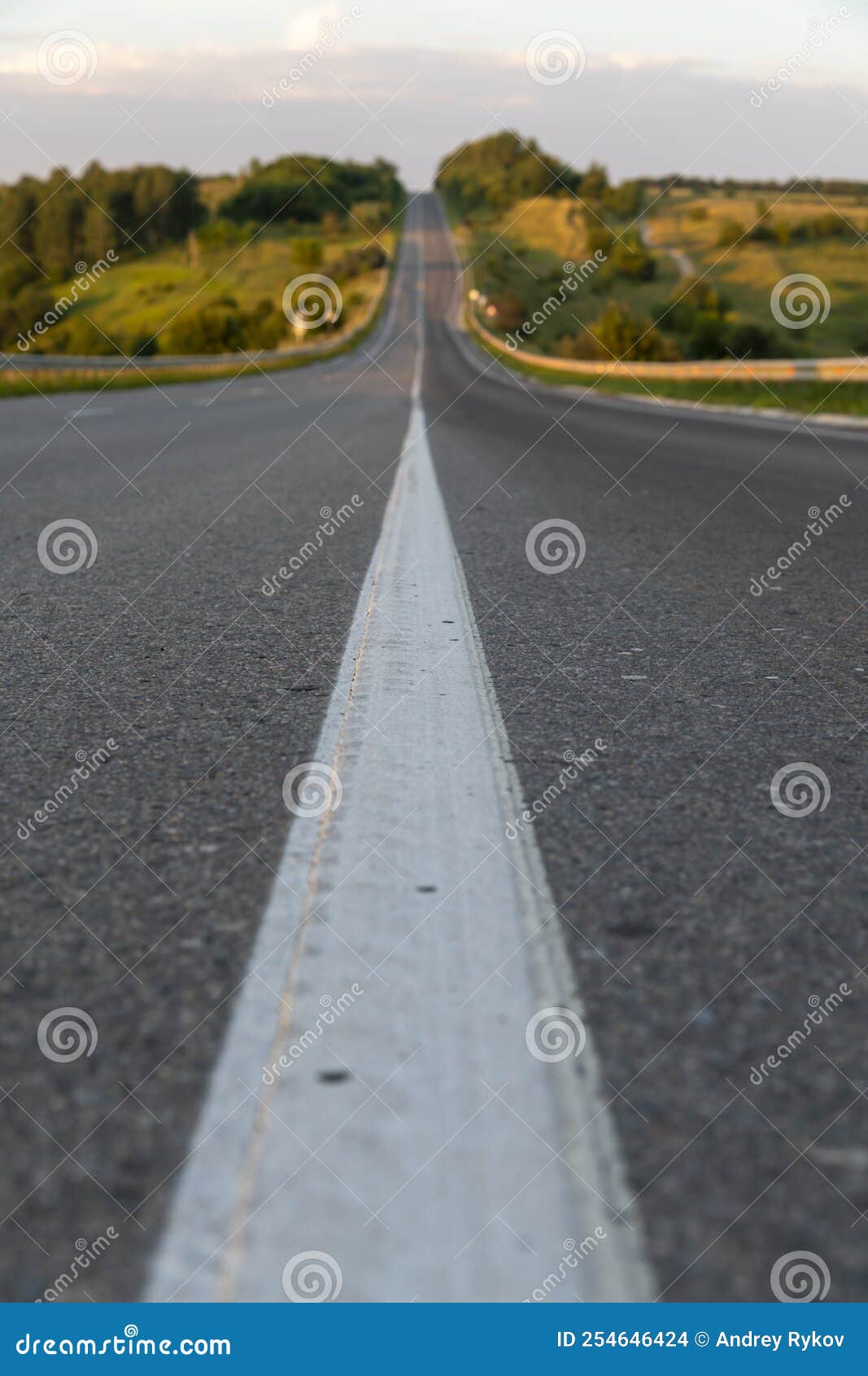 Dividing Line on Empty Road at Sunset Stock Photo - Image of empty ...
