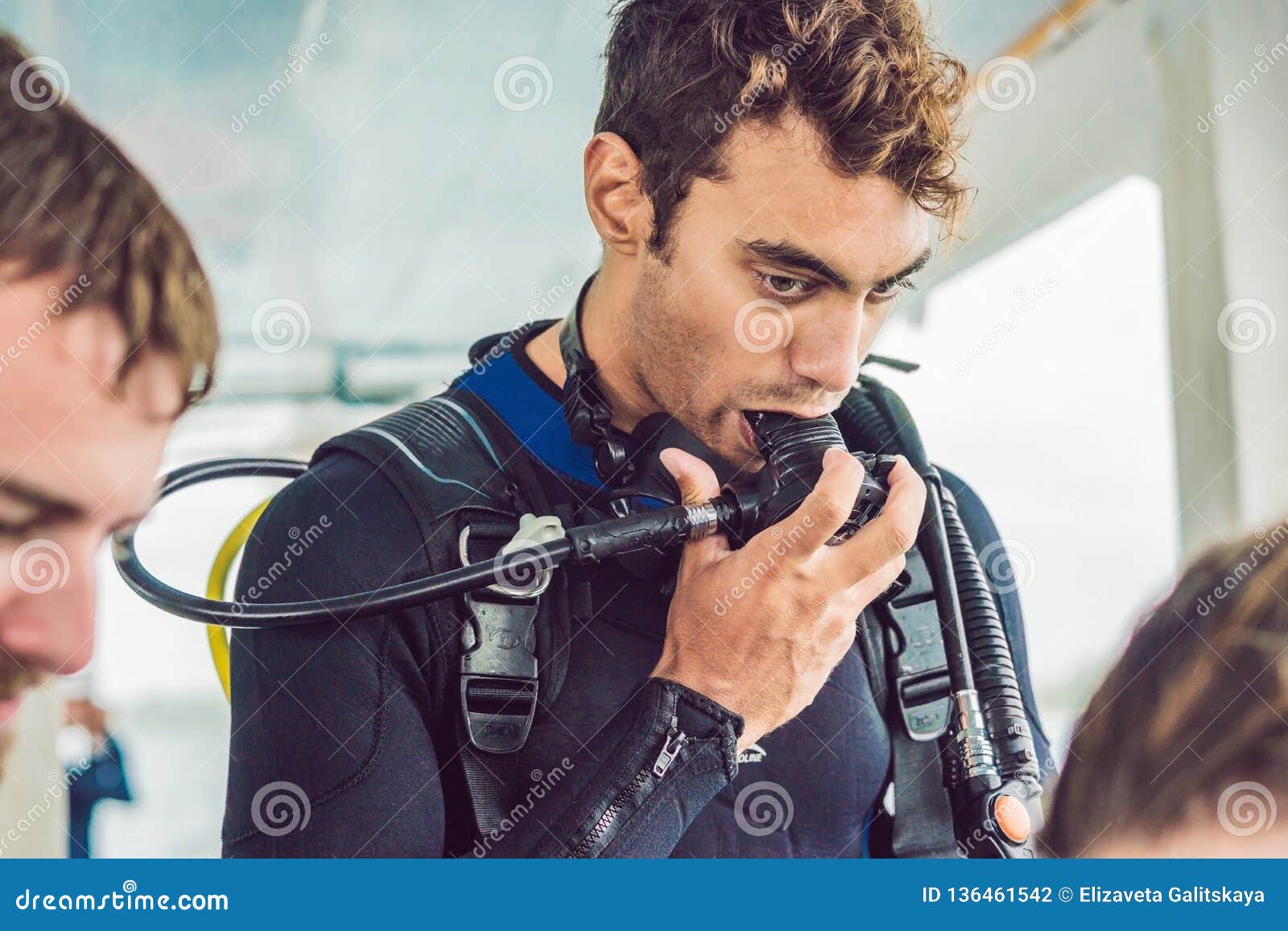 Diving Instructor Helps a Beginner Diver Prepare for Diving Stock Photo ...