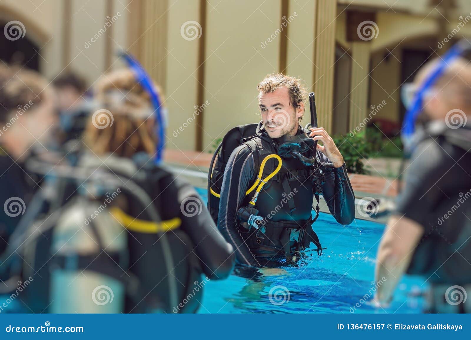 Diving Instructor and Students. Instructor Teaches Students To Dive ...