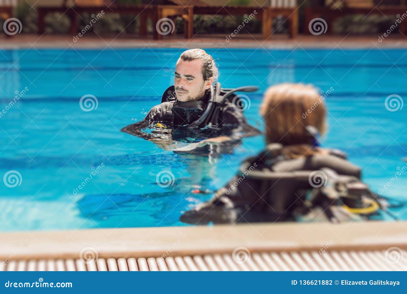 Diving Instructor and Students. Instructor Teaches Students To Dive ...