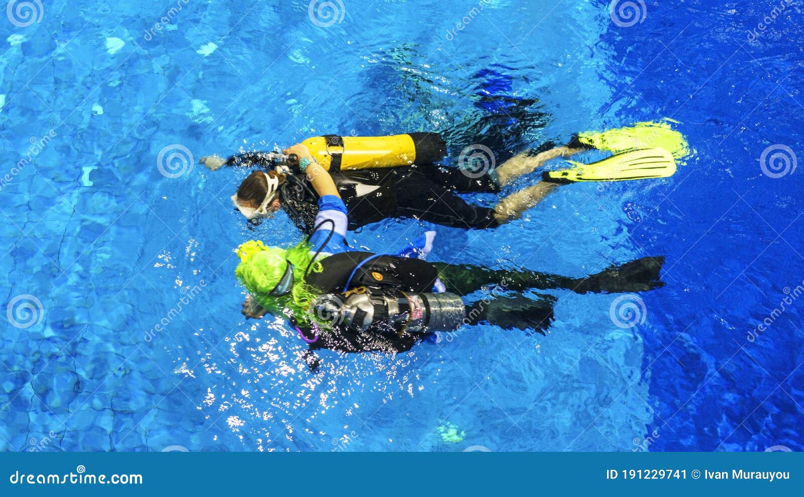 Diving Instructor and Students. Instructor Teaches Students To Dive in ...