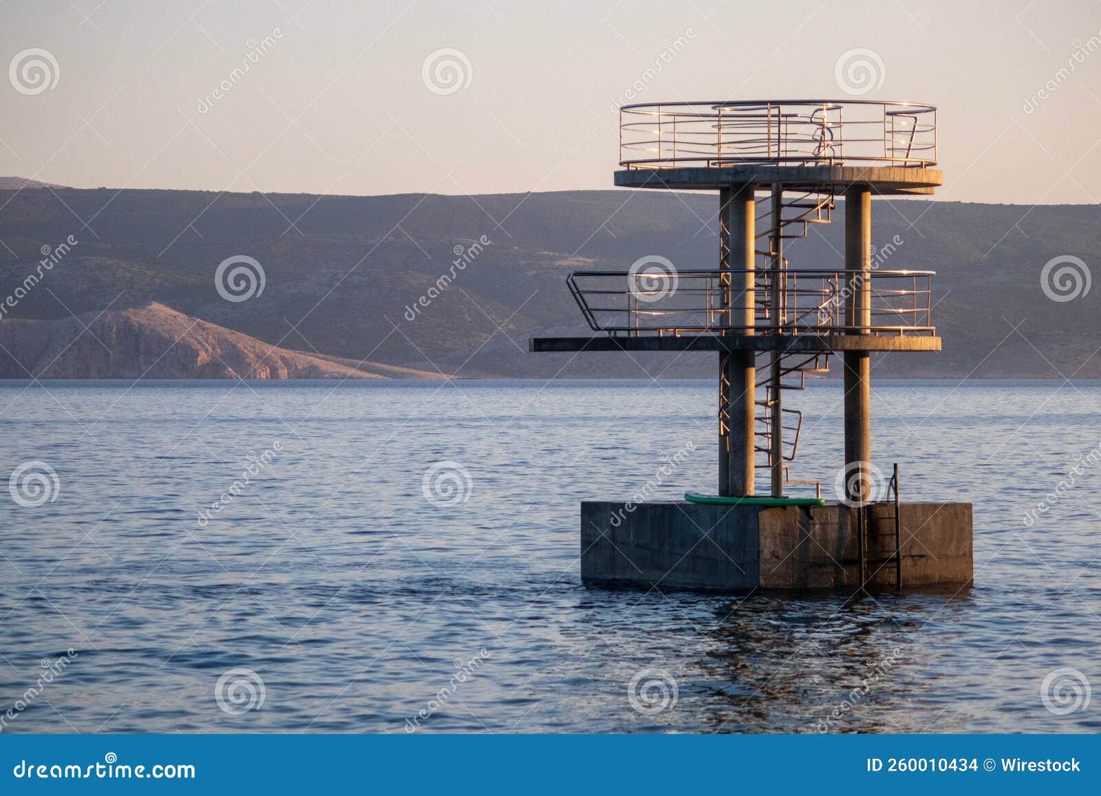 Diving Tower in the Middle of a Seascape with Mountains in the ...