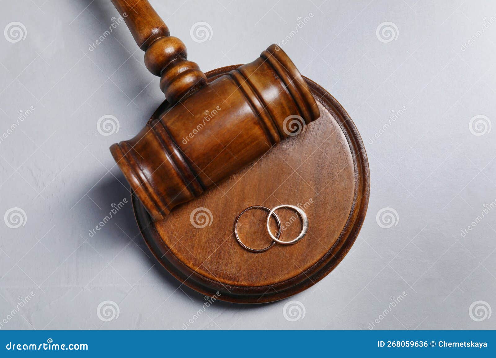 Divorce Process. Wooden Gavel and Wedding Rings on Grey Textured Table ...