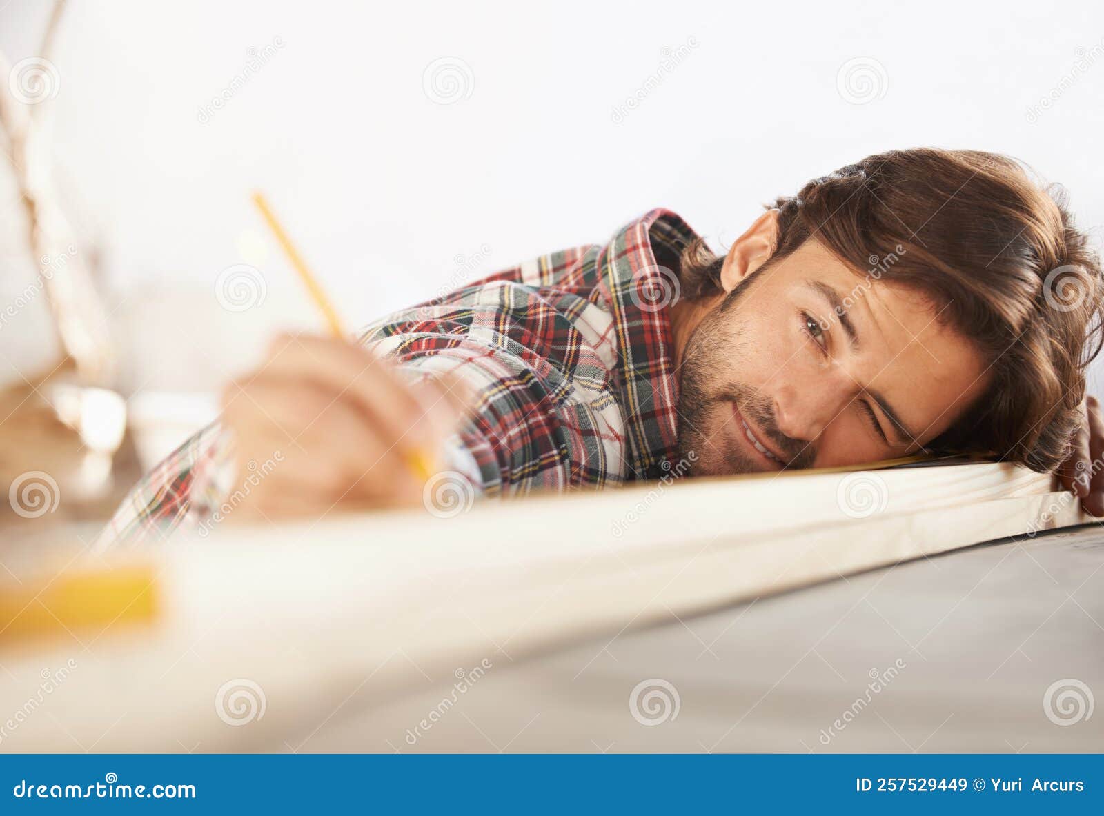 DIY Master. a Handsome Young Carpenter Measuring and Marking Wood ...