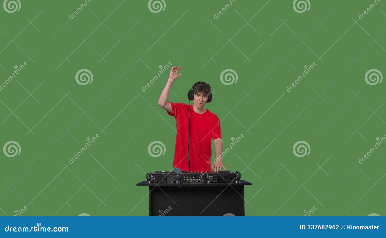 DJ Mixing Music on a Turntable in a Studio on a Green Screen Background ...