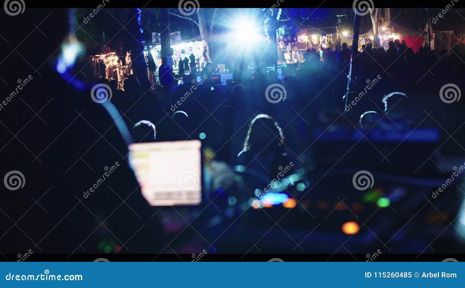 DJ Playing in a Large Trance Party with Large Crowd of People Dancing ...