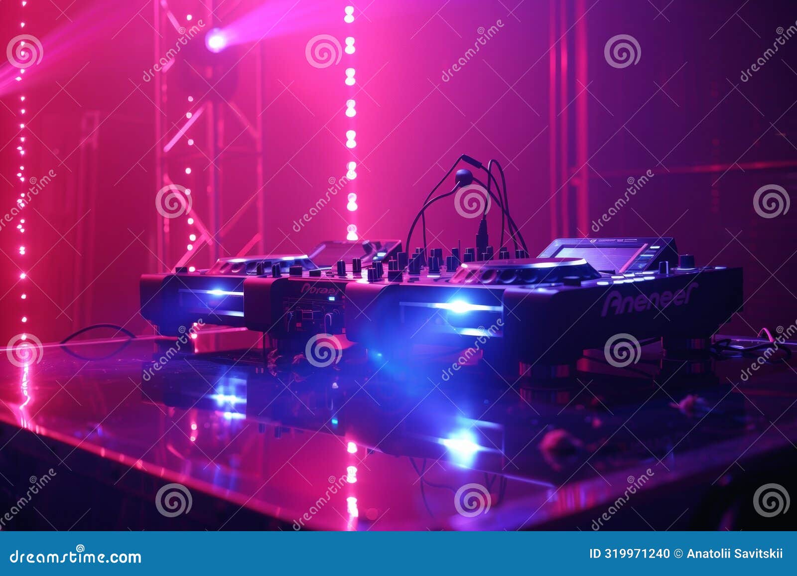 A DJ Set Up Emitting Vibrant Lights in Front of a Mesmerizing Purple ...