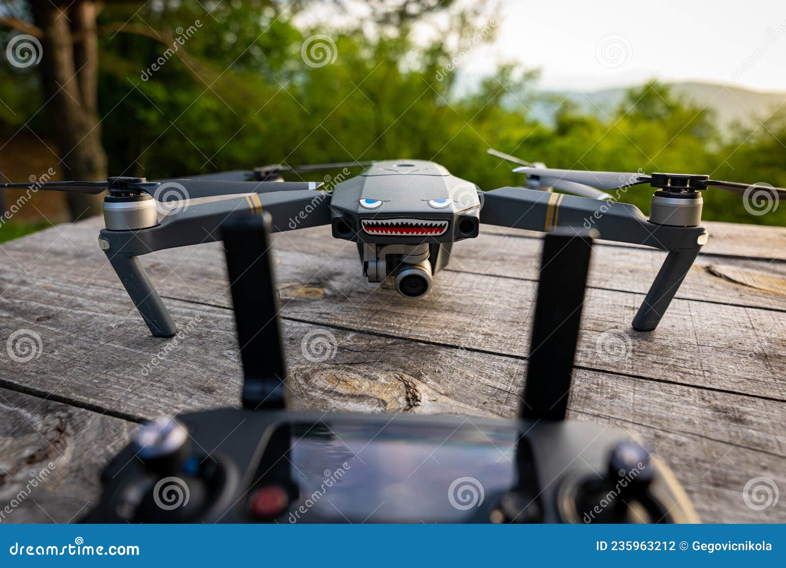 DJI Mavic Pro Drone and Its Controller with Antennas on a Wooden Table ...