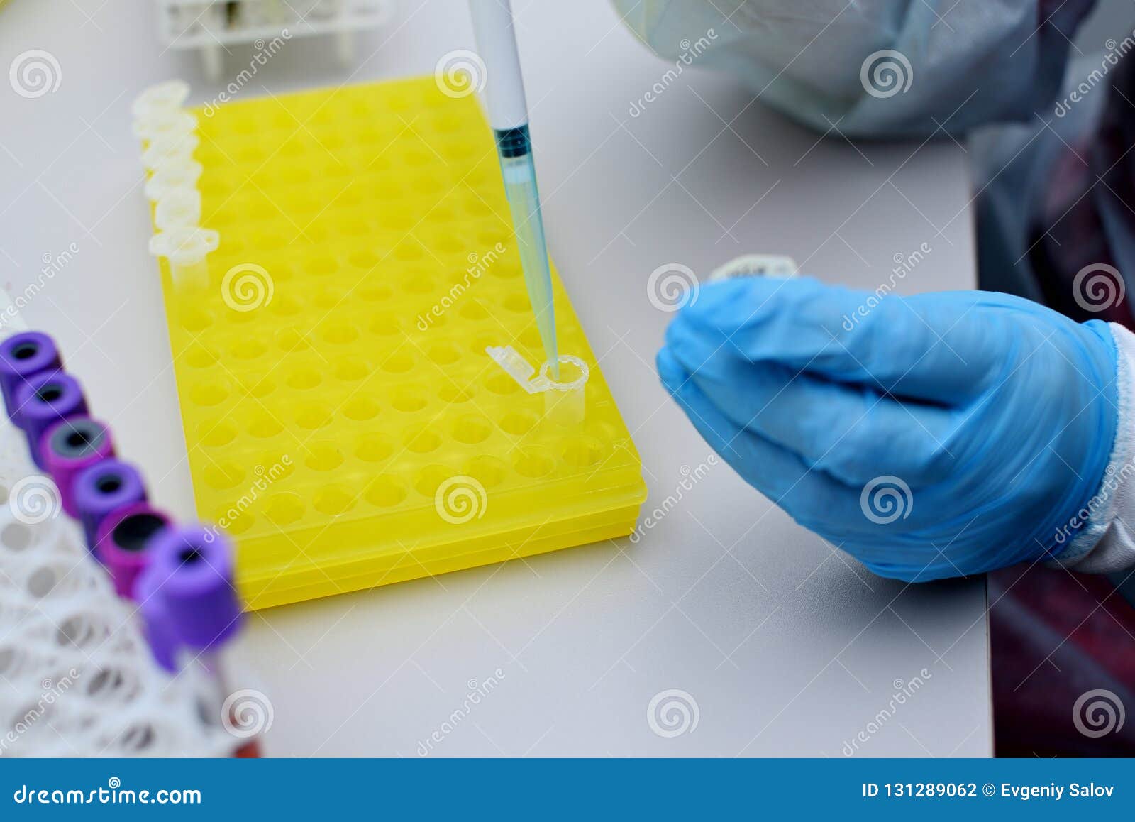 Dna Test in the Lab. a Lab Technician Dripping Blood into a Test Tube ...
