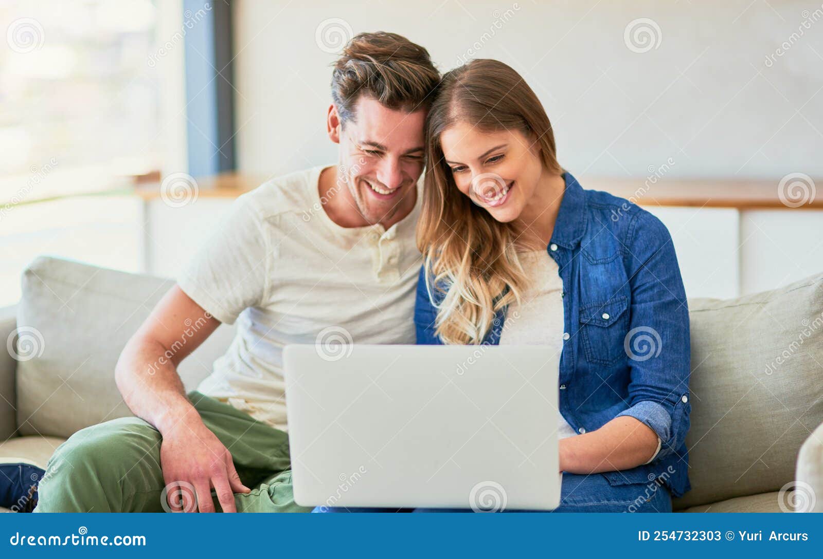 They Do Everything Together. an Affectionate Young Couple Using Their ...