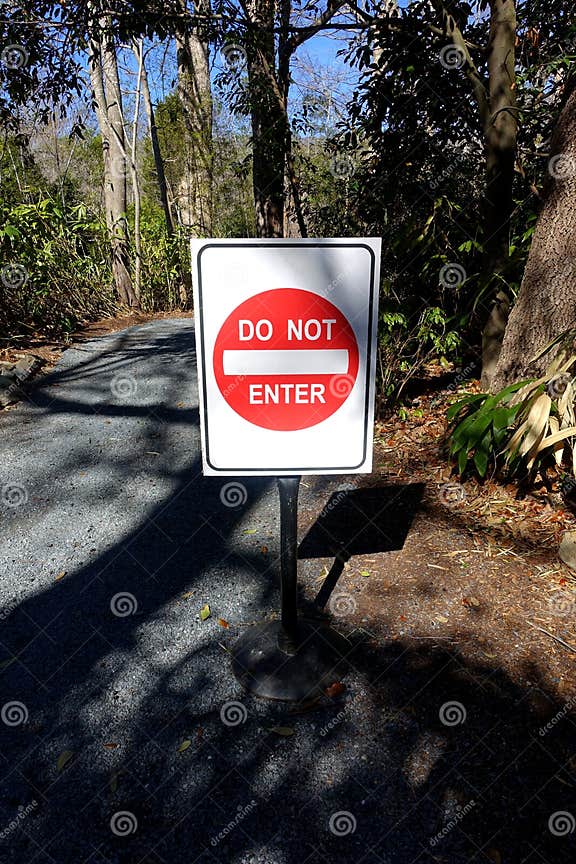 DO NOT ENTER Sign on a Paved Path in the Woods Stock Photo - Image of ...
