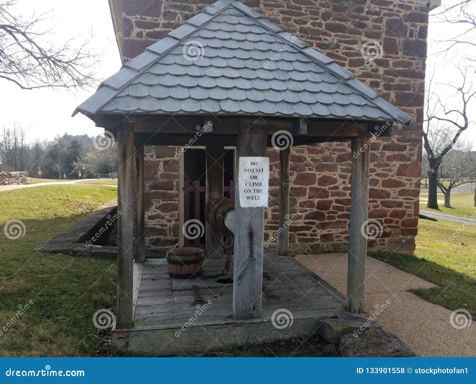 Do Not Sit or Climb on the Well Sign on Wooden Well Stock Photo - Image ...
