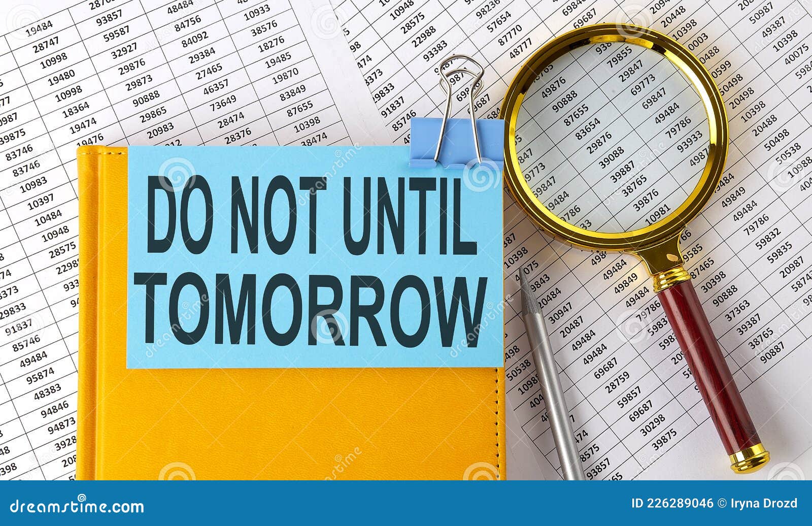 Do Not Wait until Tomorrow Text on Sticker on Notebook with Magnifier ...