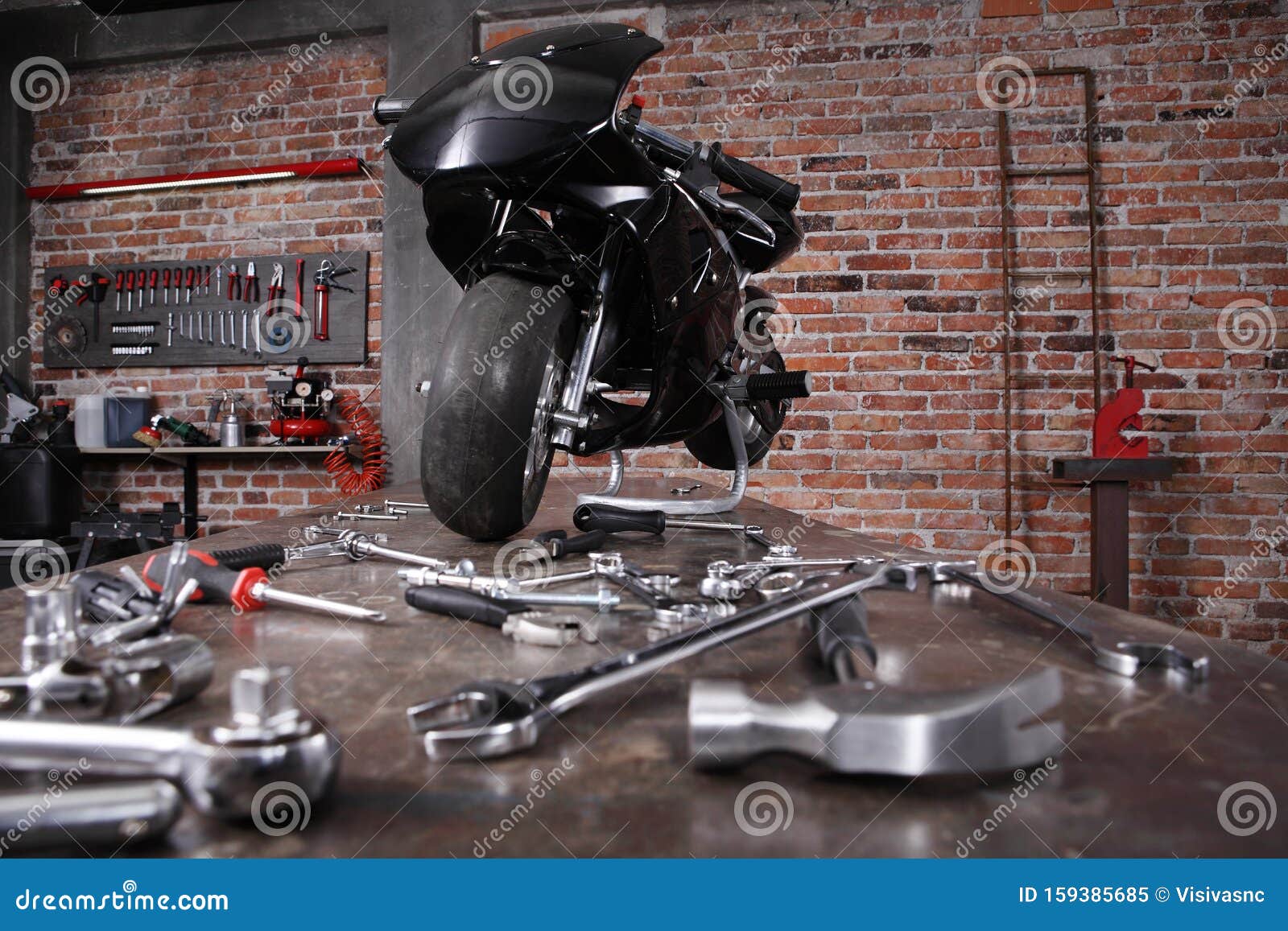 Do it Yourself Concept, Motorcycle in the Garage with Red Brick Wall ...
