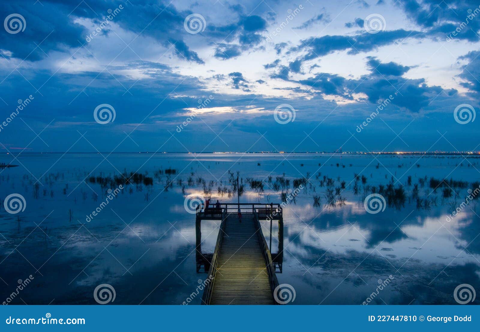 Dock on the bay at sunset stock photo. Image of gulf - 227447810