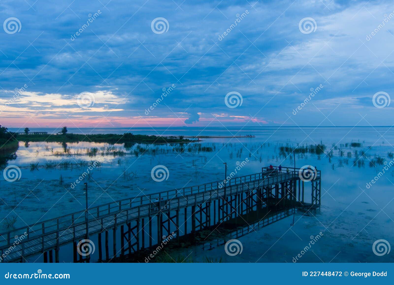 Dock on the bay at sunset stock photo. Image of ocean - 227448472
