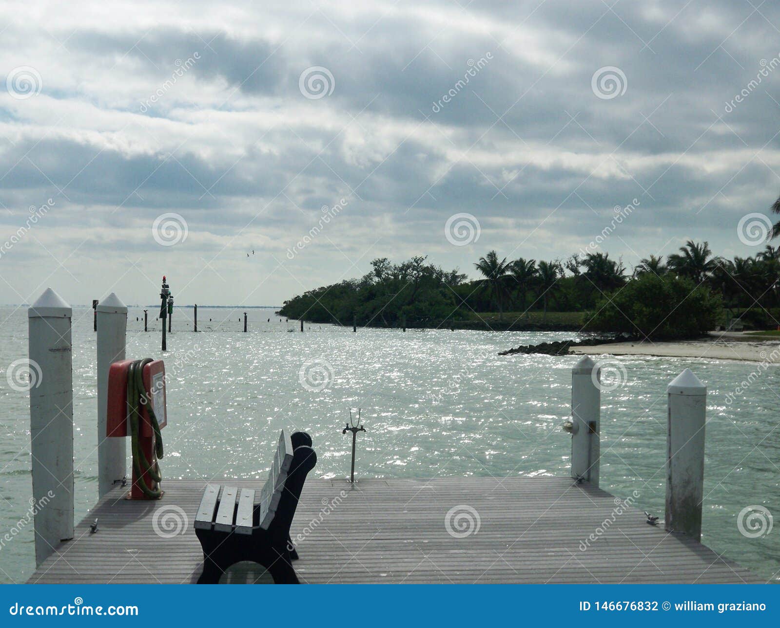 Dock with a Bench Overlooking Water on a Cloudy Day. Stock Photo ...