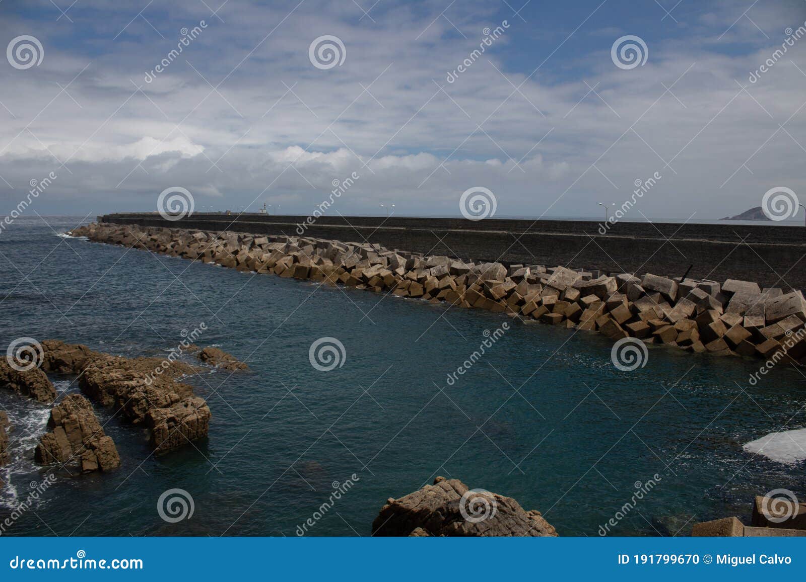 Dock with Cube Shaped Rocks Stock Photo - Image of water, blur: 191799670